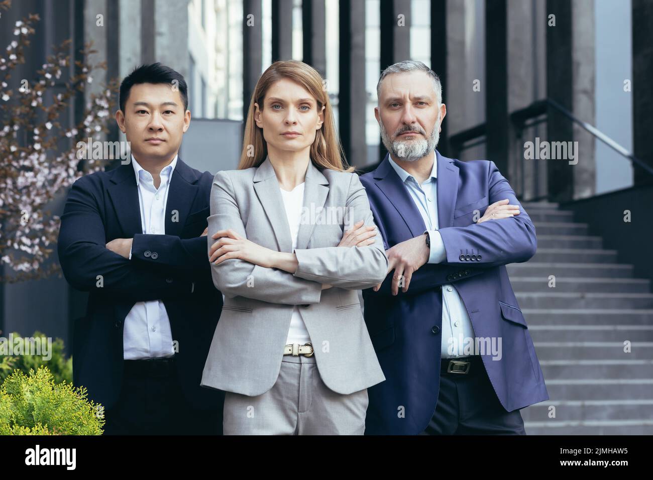 Serious and confident female boss with team of workers, group of ...
