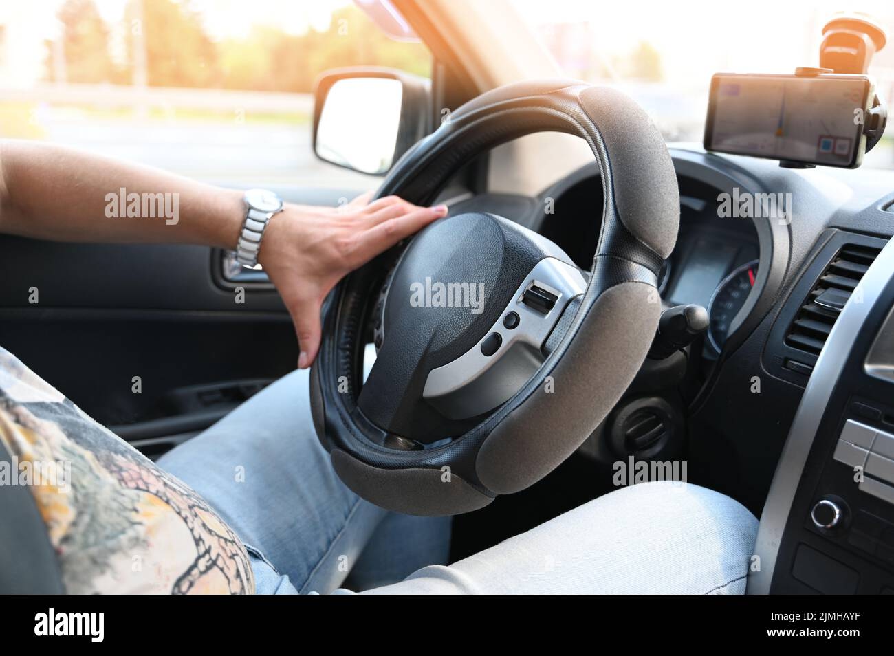 concept of a dangerous journey. One hand of a man holds the steering ...