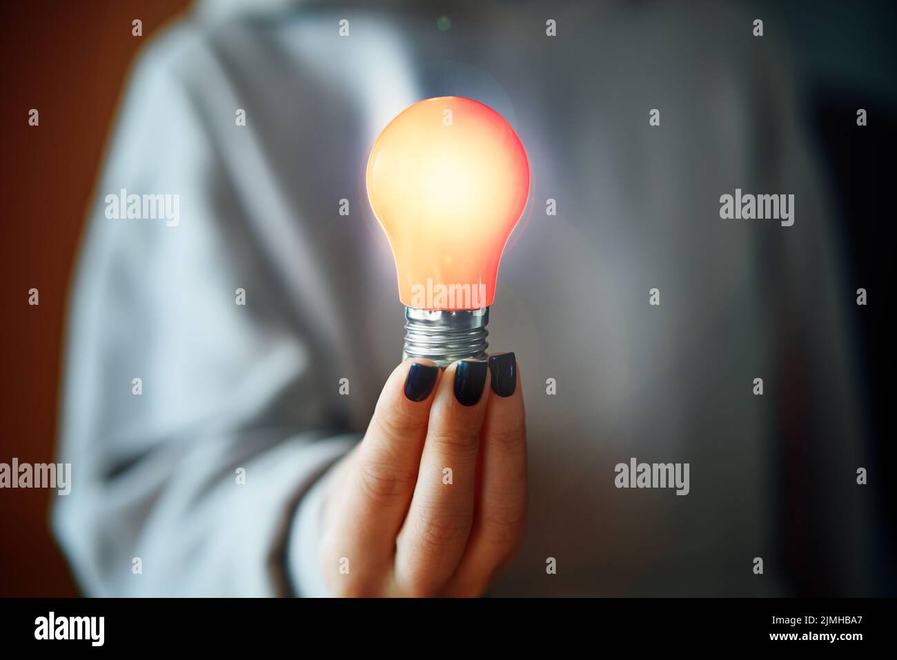 Woman hold in hand glowing light bulb. New idea and innovation concept ...