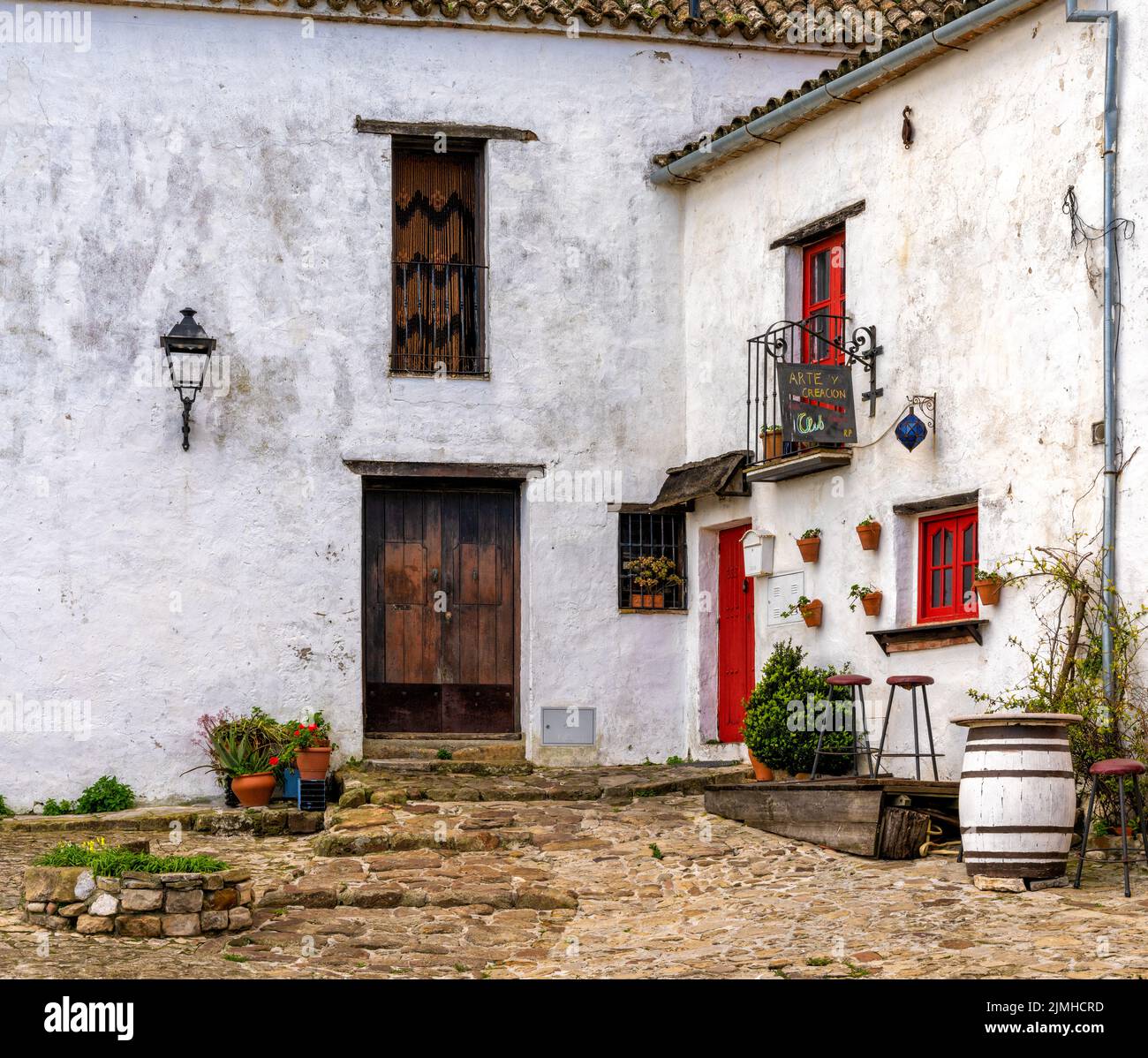 Old whitewashed buildings and colorful decorations and plants Stock ...