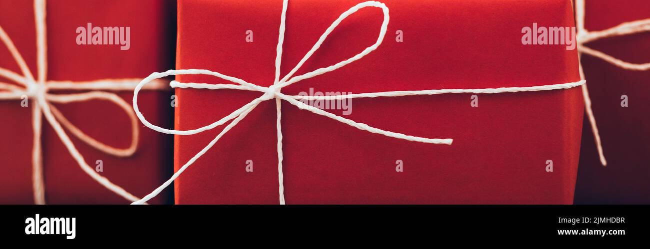 holiday surprise red paper gift boxes white cord Stock Photo - Alamy