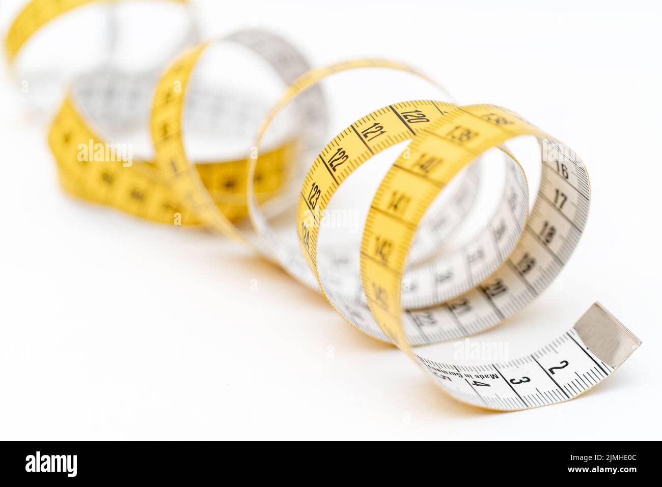 Yellow measuring tape on white background. Measurement of length and ...