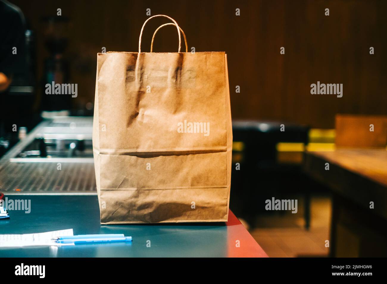 Paper eco bag with food in a restaurant station waiting for courier ...