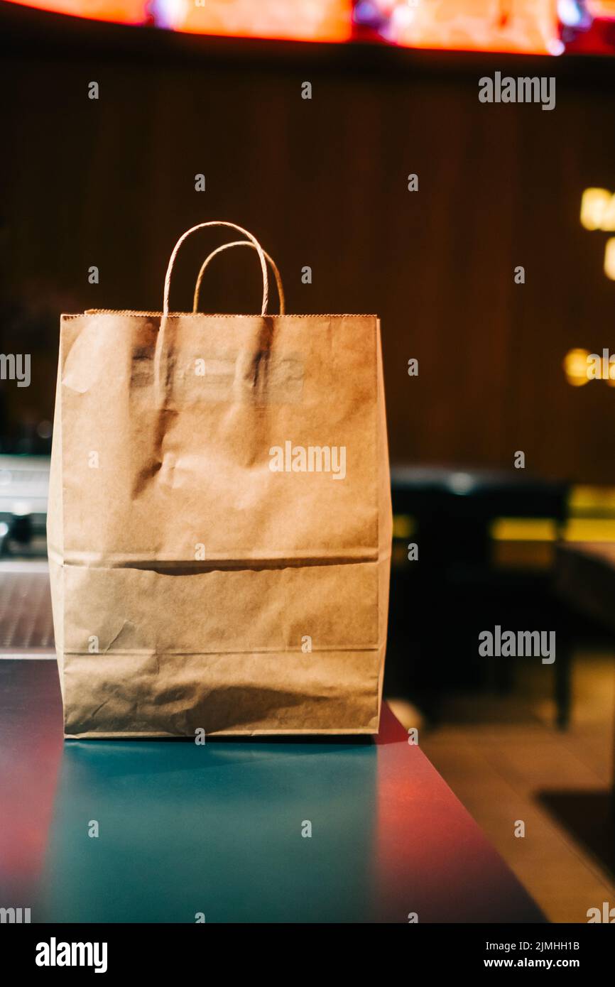 Paper eco bag with food in a restaurant station waiting for courier ...