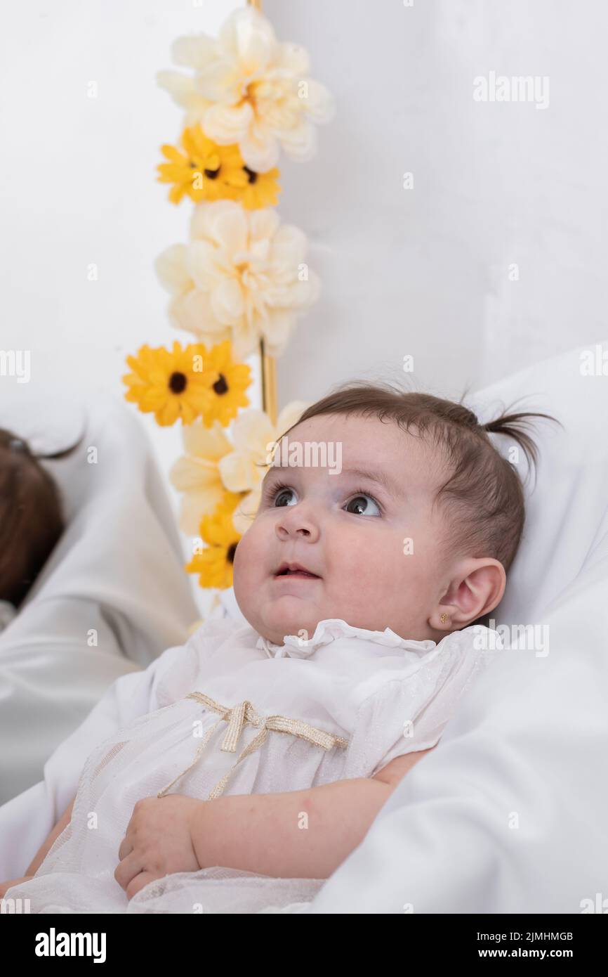 beautiful latin baby girl, very happy looking at her mother, lying on a ...