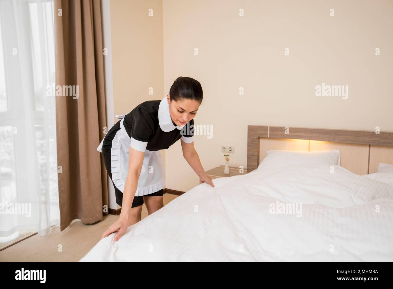 Chambermaid preparing hotel room Stock Photo - Alamy