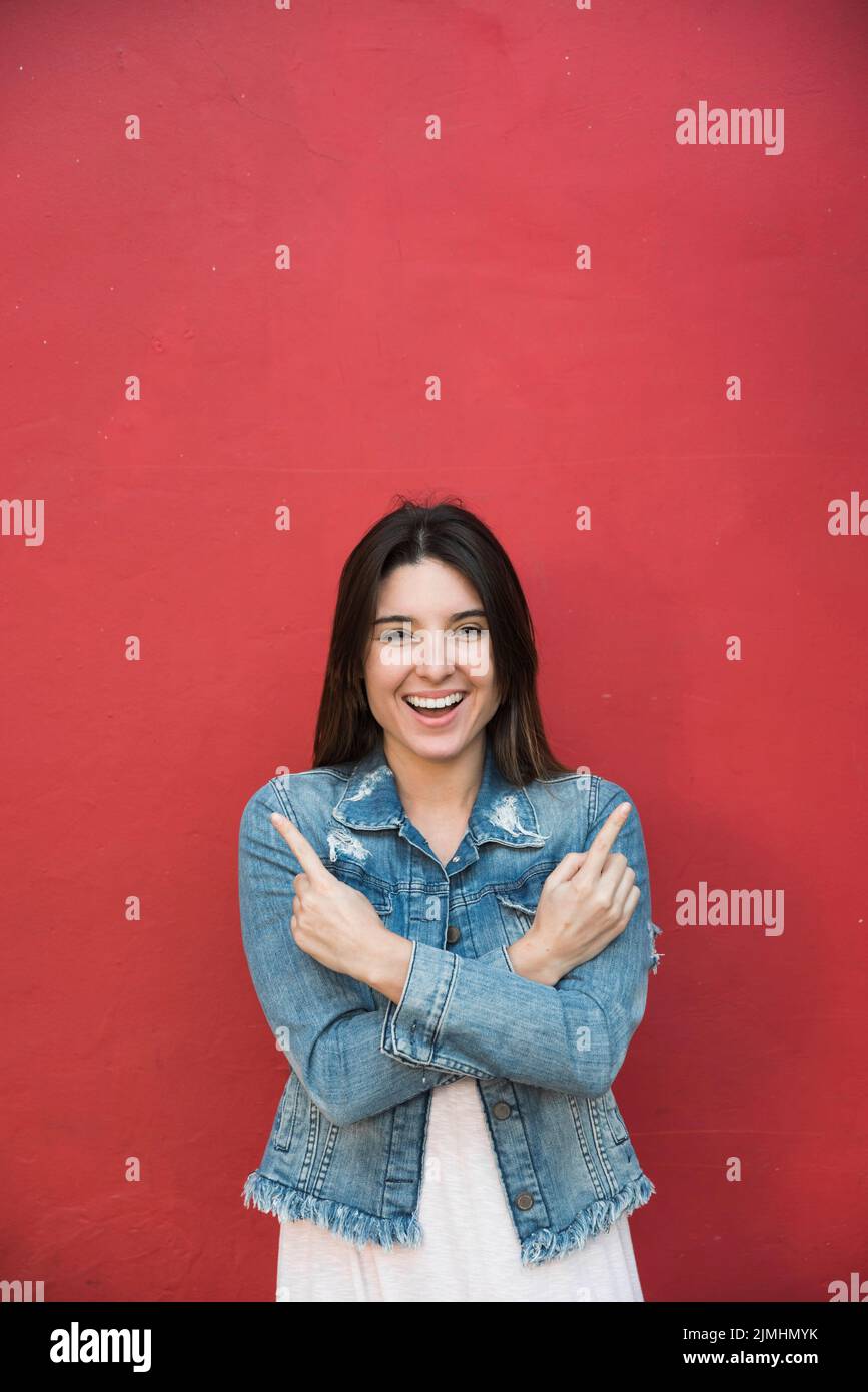 Smiling lady showing fingers Stock Photo - Alamy