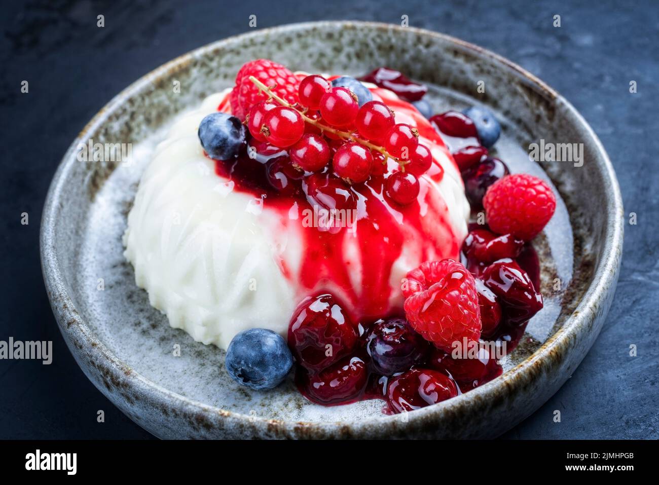 Modern style traditional blancmange almond pudding with wild berry ...