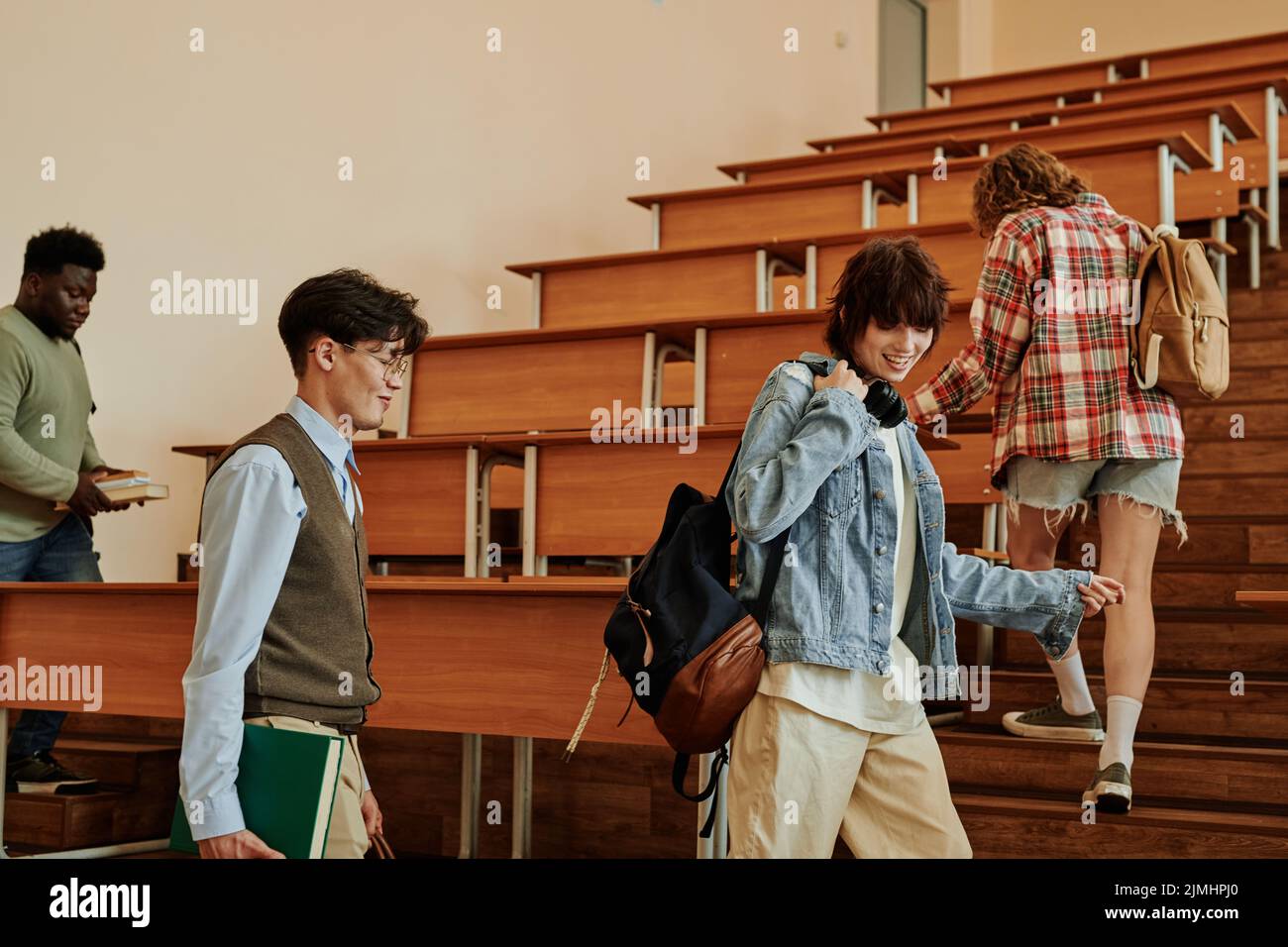 Group of intercultural teenage students in casualwear having talk while ...