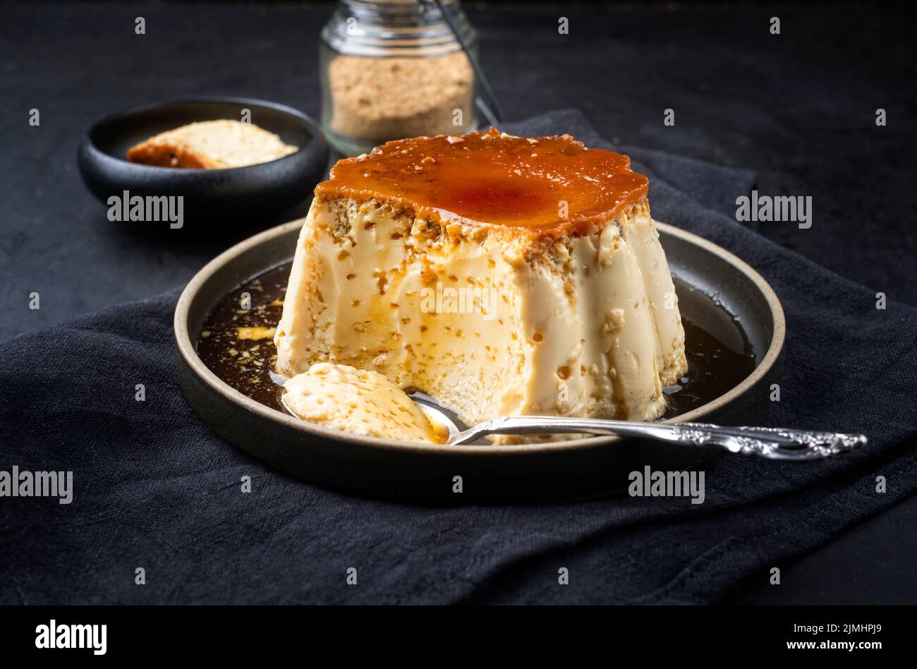 Modern style traditional creme caramel pudding served as close-up in a ...