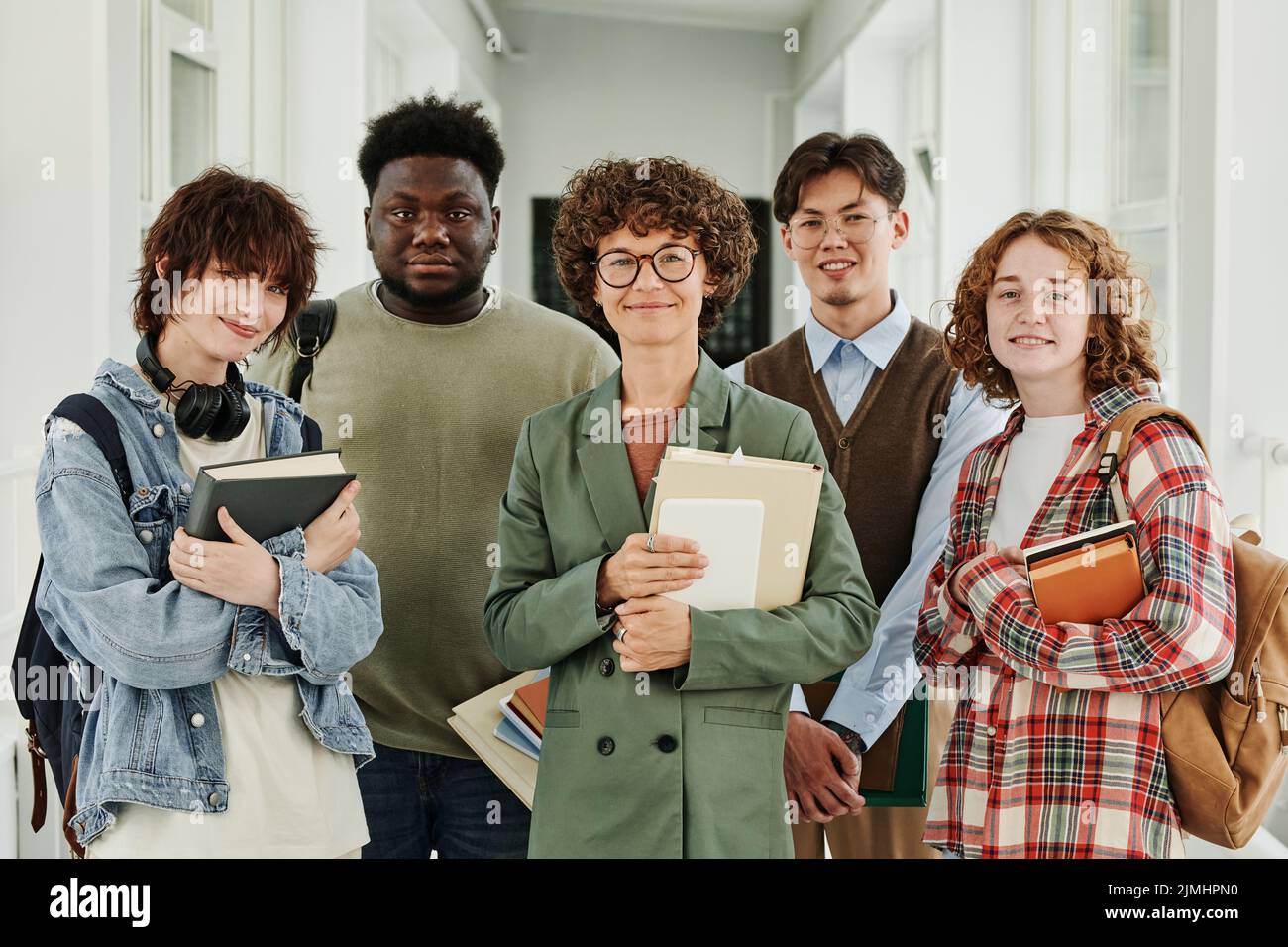 Group of happy teenage classmates and their teacher in casualwear ...