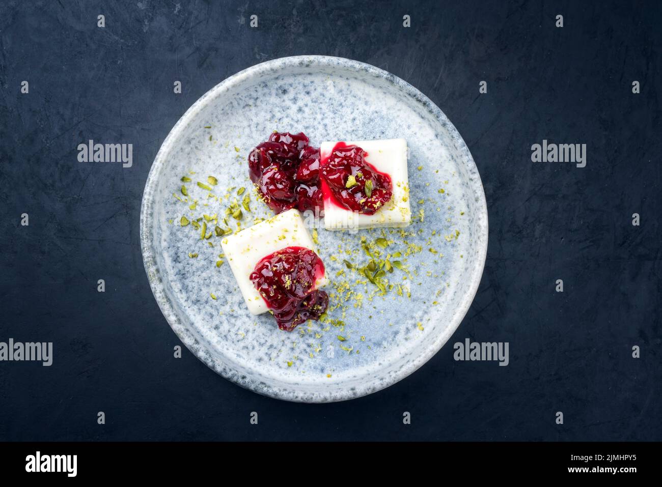 Modern style traditional blancmange almond pudding with sour cherry ...
