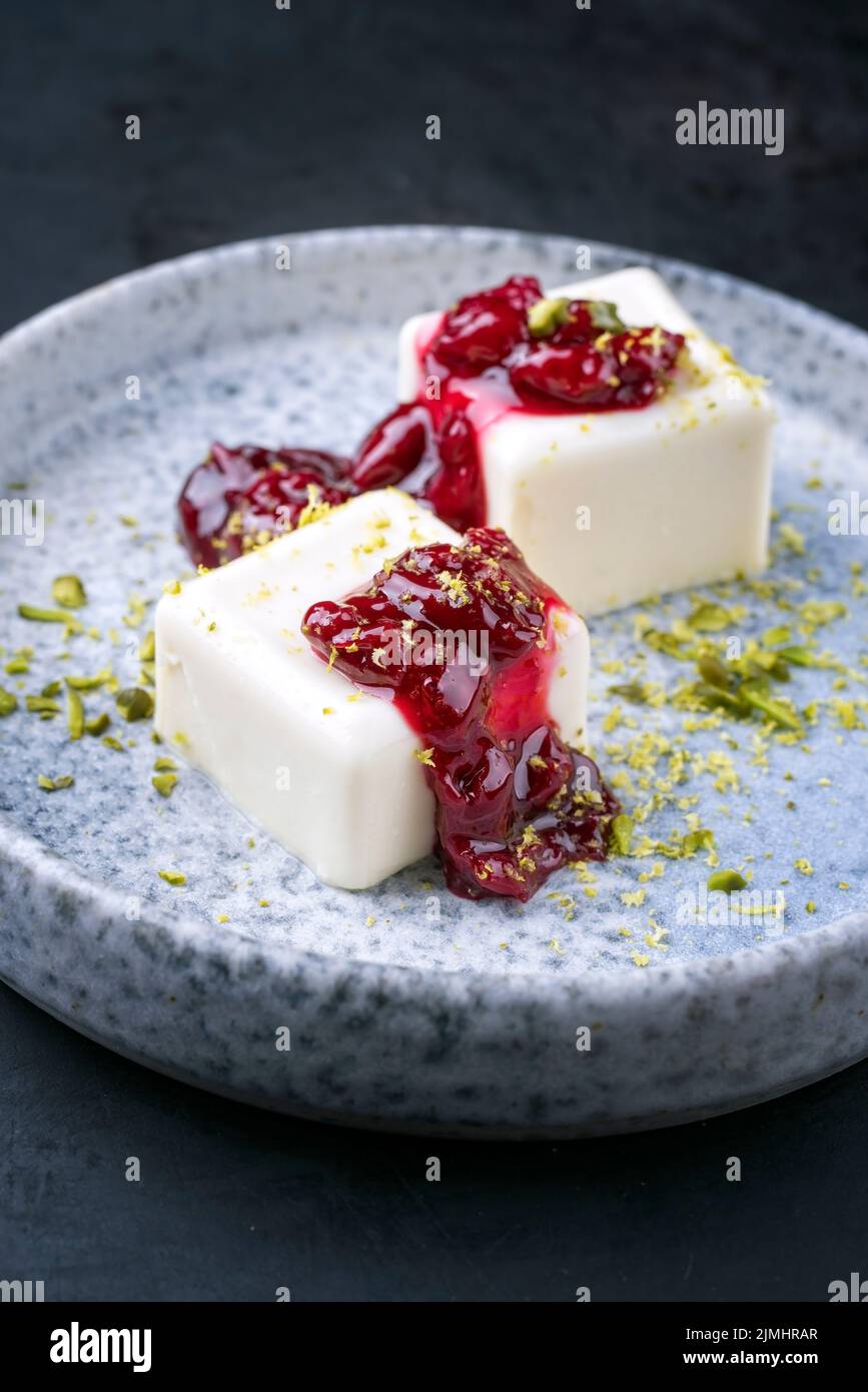 Modern style traditional blancmange almond pudding with sour cherry ...