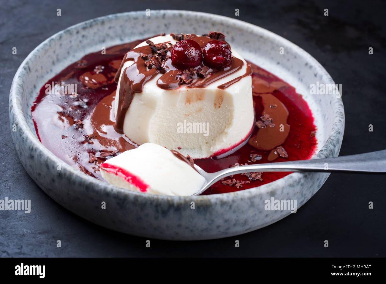 Modern style traditional blancmange almond pudding with cherry Stock ...