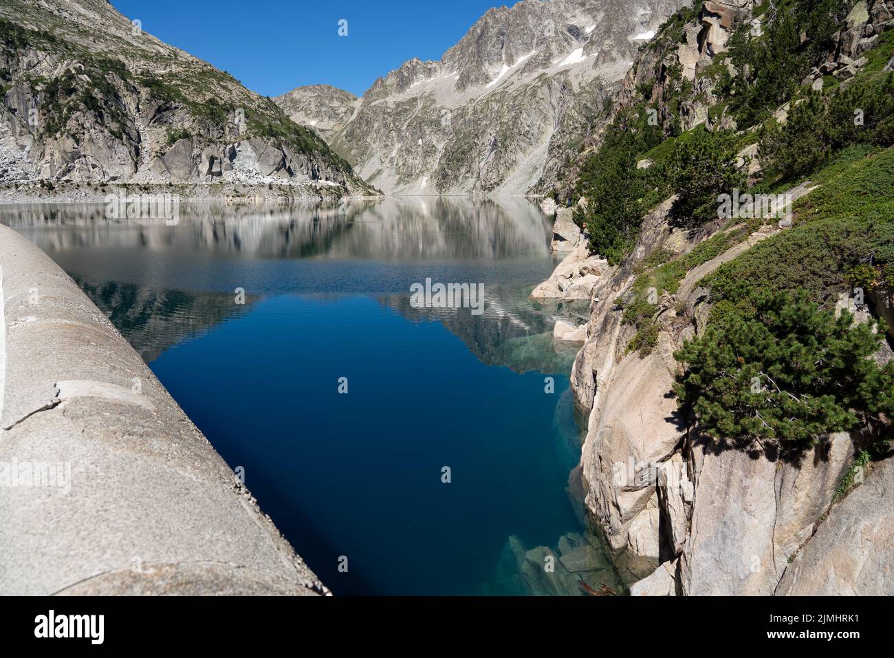 mountain reflection in still blue water lake, Lac de Cap-de-Long ...