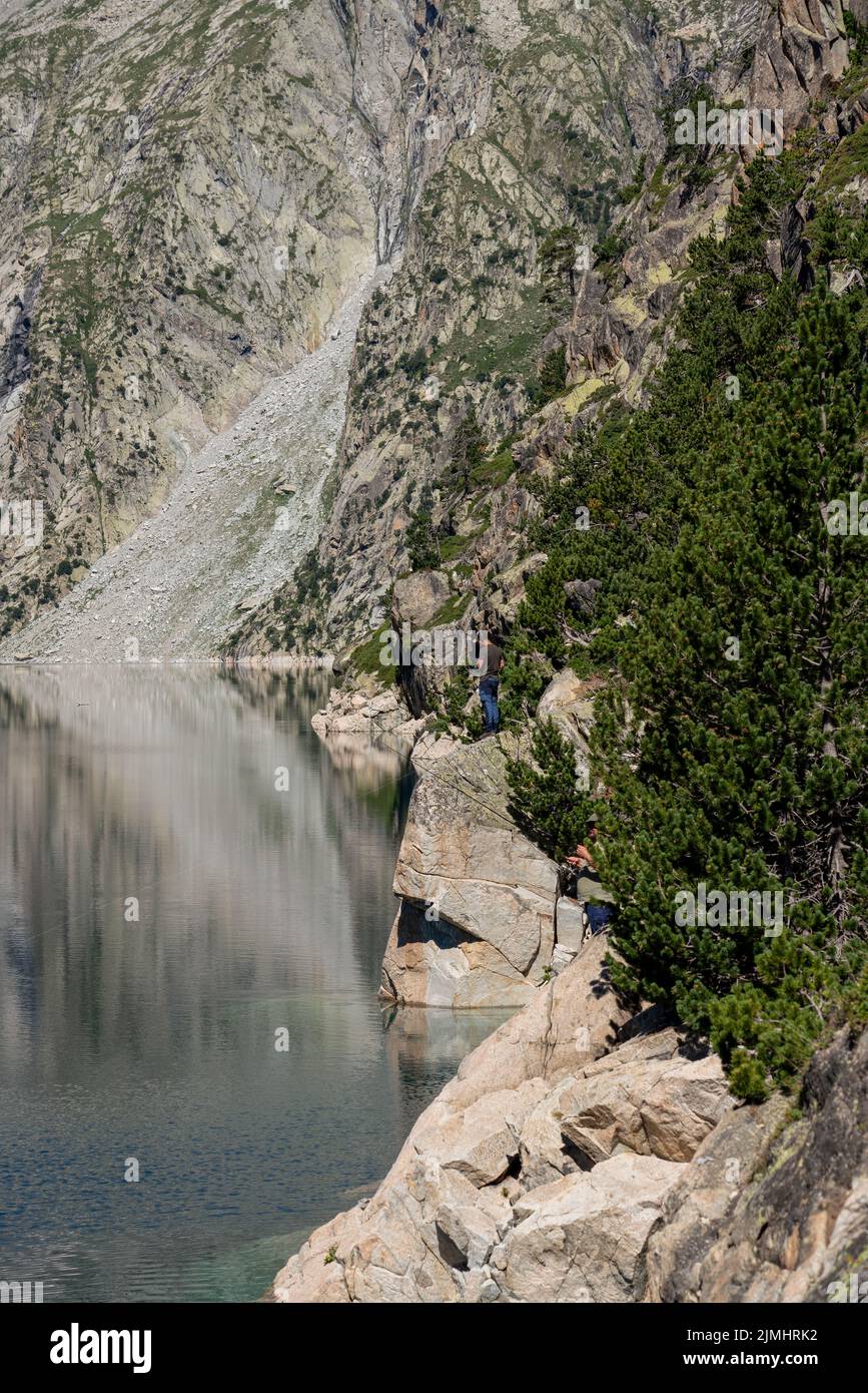 mountain reflection in still blue water lake, Lac de Cap-de-Long ...