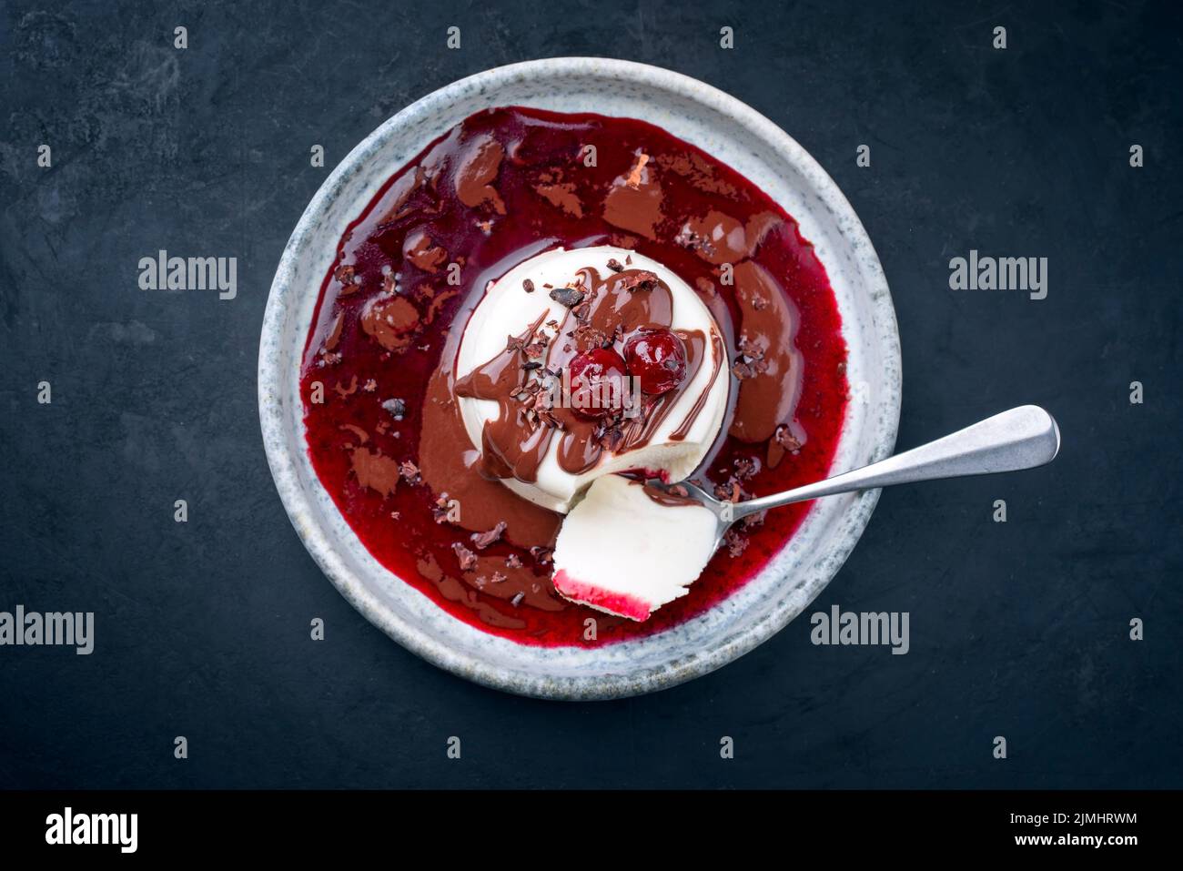 Modern style traditional blancmange almond pudding with cherry Stock ...