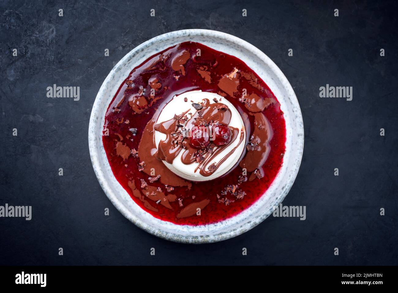 Modern style traditional blancmange almond pudding with cherry Stock ...