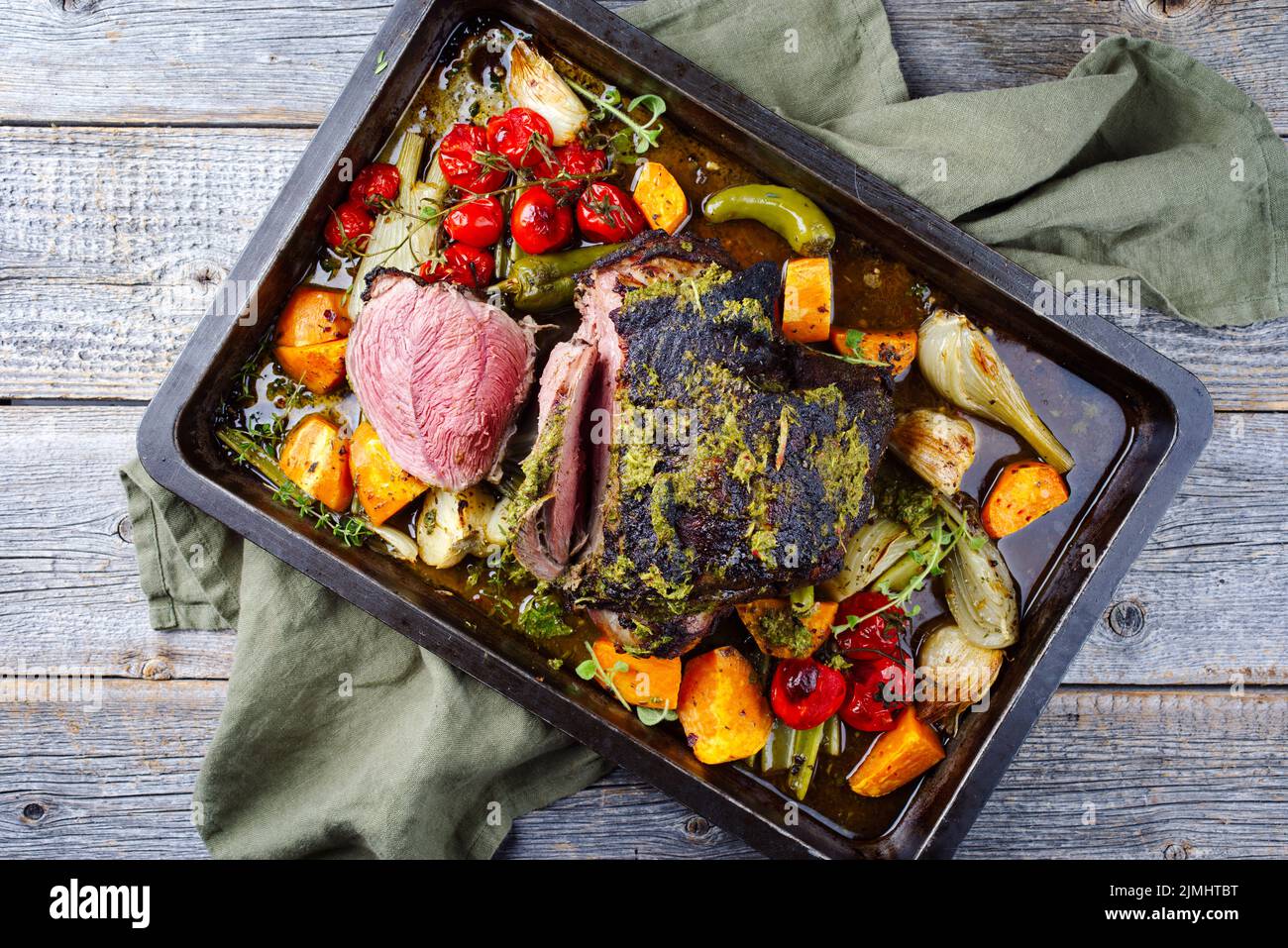 Traditional English barbecue lamb roast with mint leaf and vegetable ...