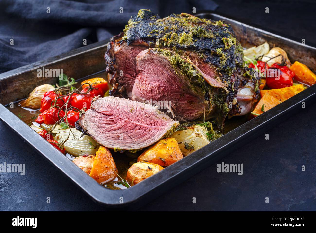 Traditional English barbecue lamb roast with mint leaf and vegetable ...