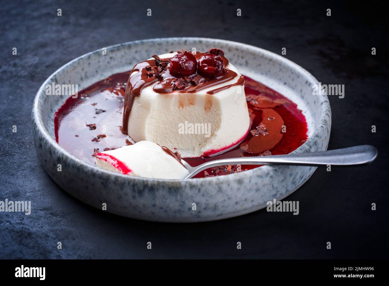 Modern style traditional blancmange almond pudding with cherry Stock ...