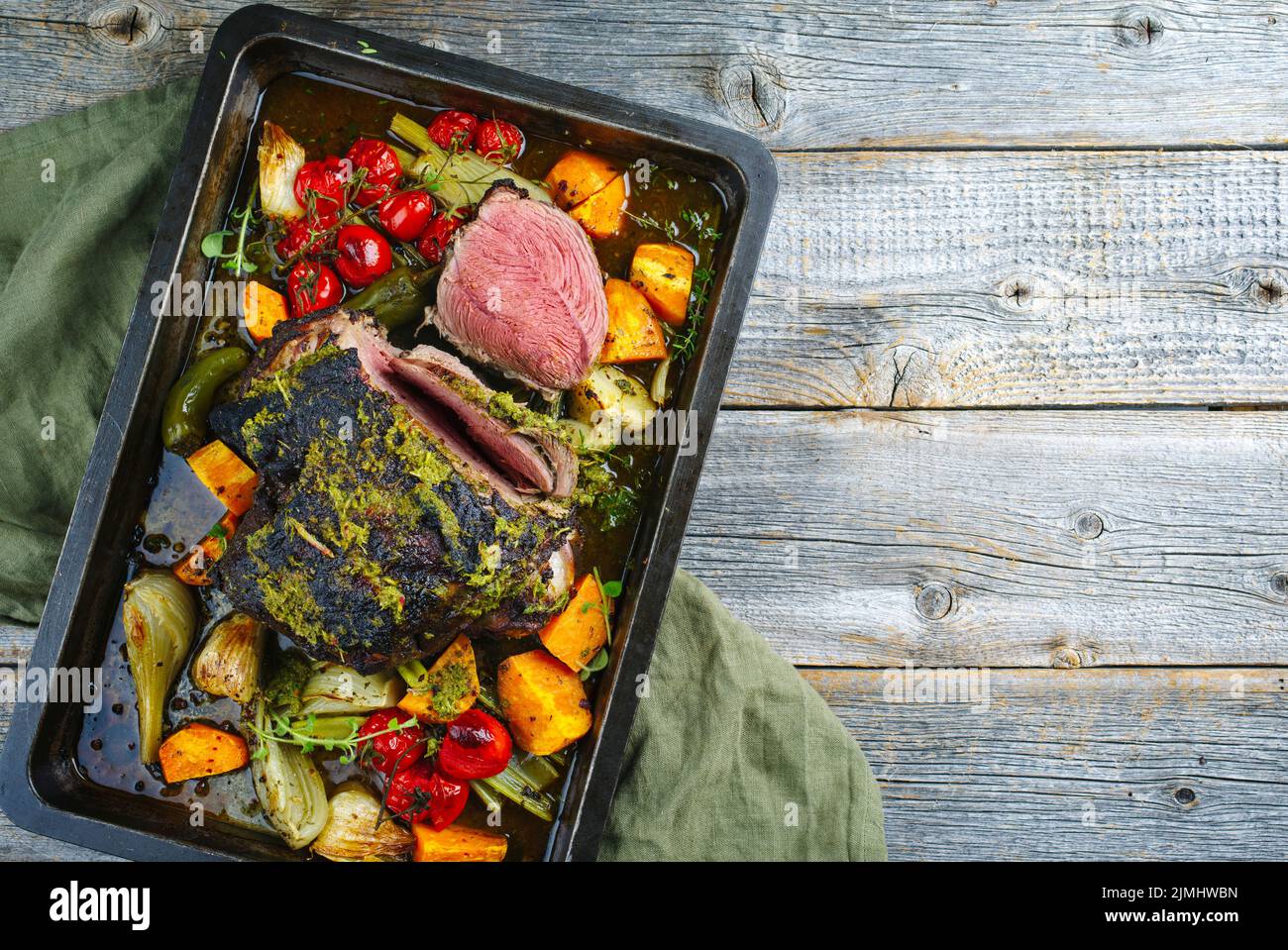Traditional English barbecue lamb roast with mint leaf and vegetable ...