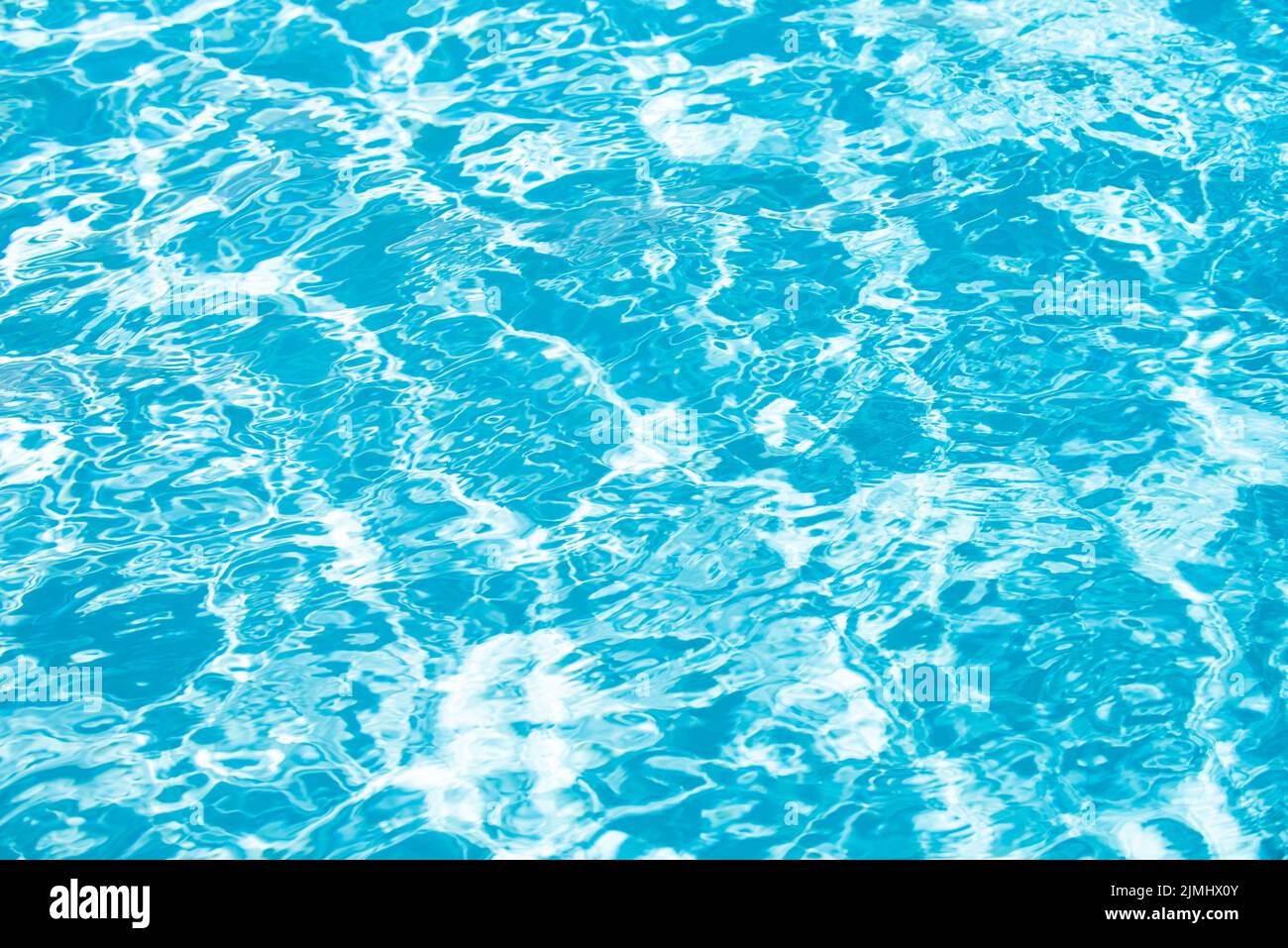 Background of blue water in swimming pool with sun reflection, ripple ...