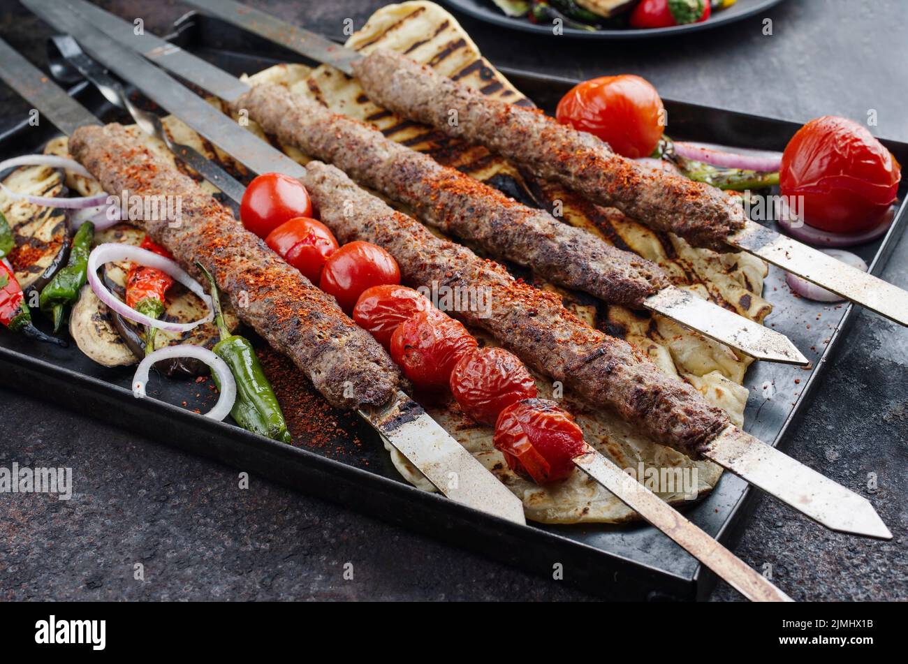 Traditional Turk Adana kebap on shashlik skewer with barbecue vegetable ...