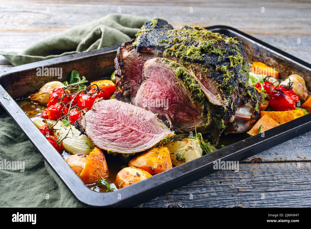 Traditional English barbecue lamb roast with mint leaf and vegetable ...
