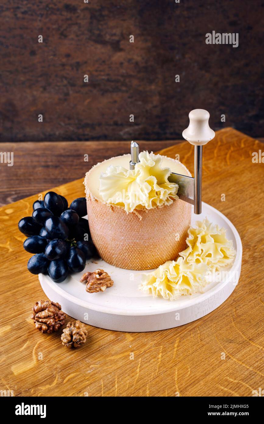 Traditional tete de moine aged mountain cheese of the Alps served with ...