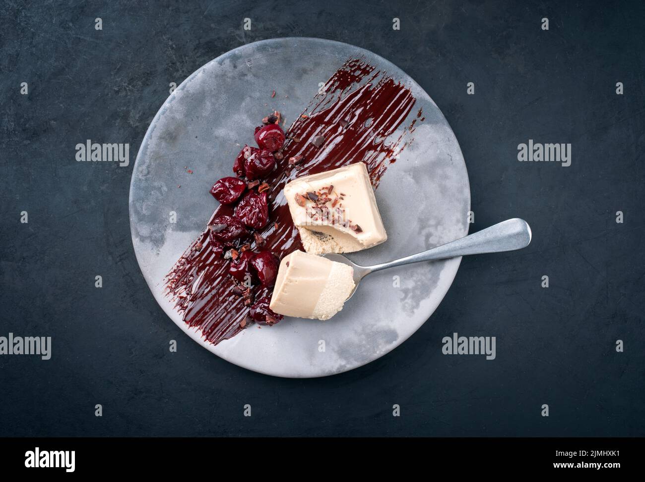 Modern style traditional blancmange almond pudding with cherry Stock ...