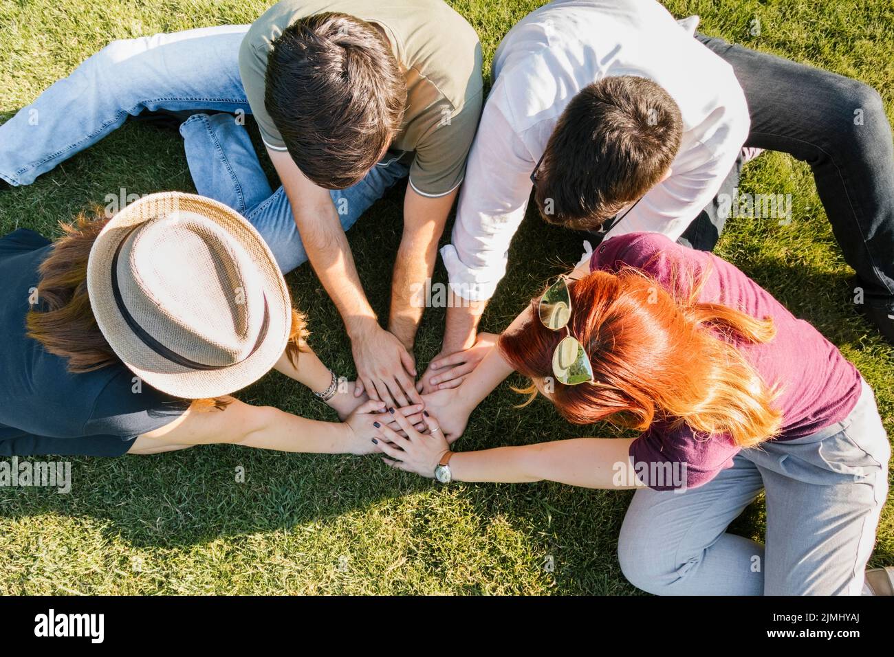 Group adult friends putting hands together Stock Photo - Alamy