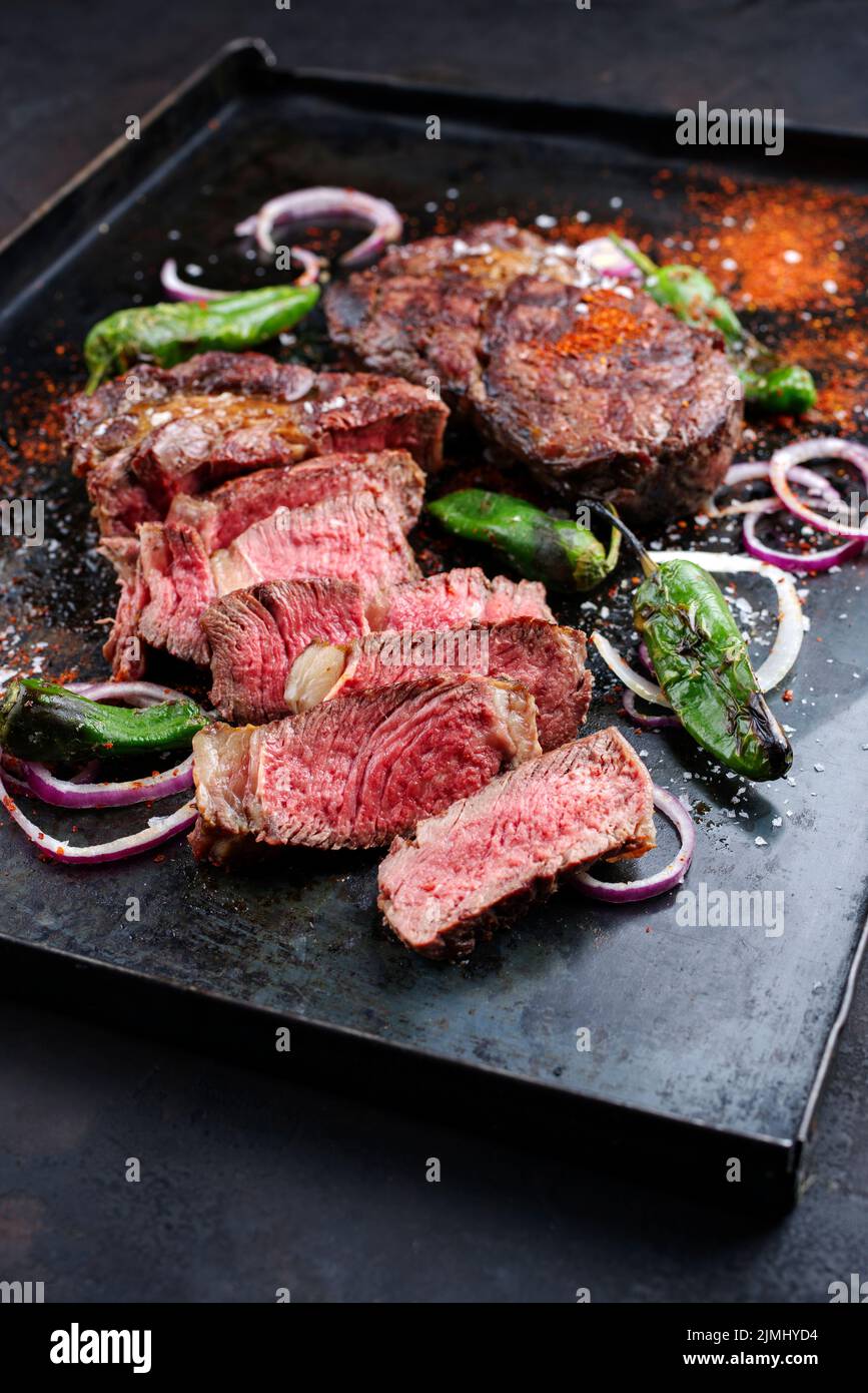 Traditional barbecue dry aged wagyu rib-eye beef steaks served with ...