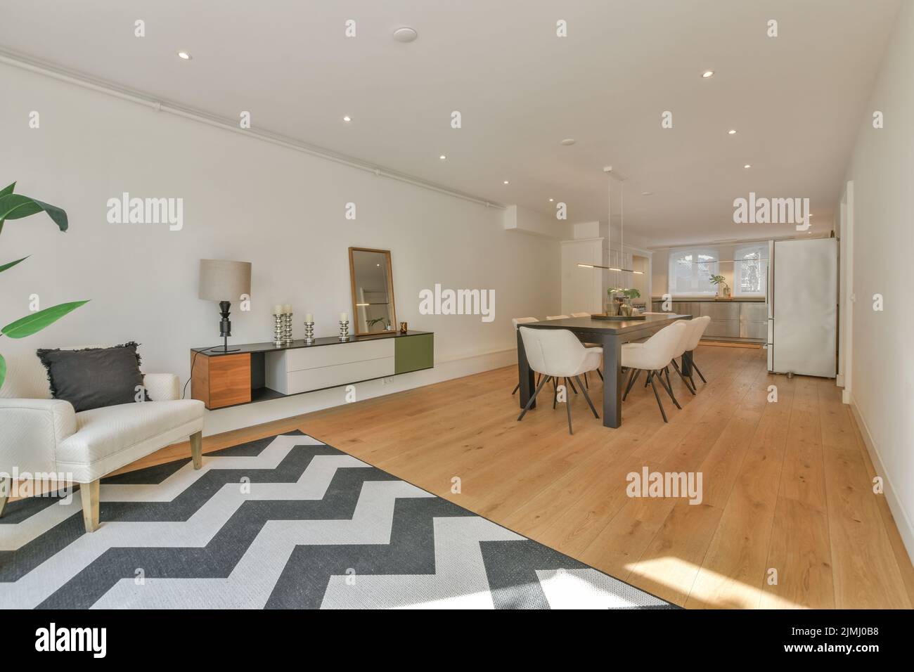 Couches and table located near dining area of spacious room in ...