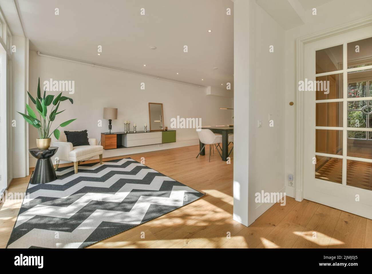 Couches and table located near dining area of spacious room in ...