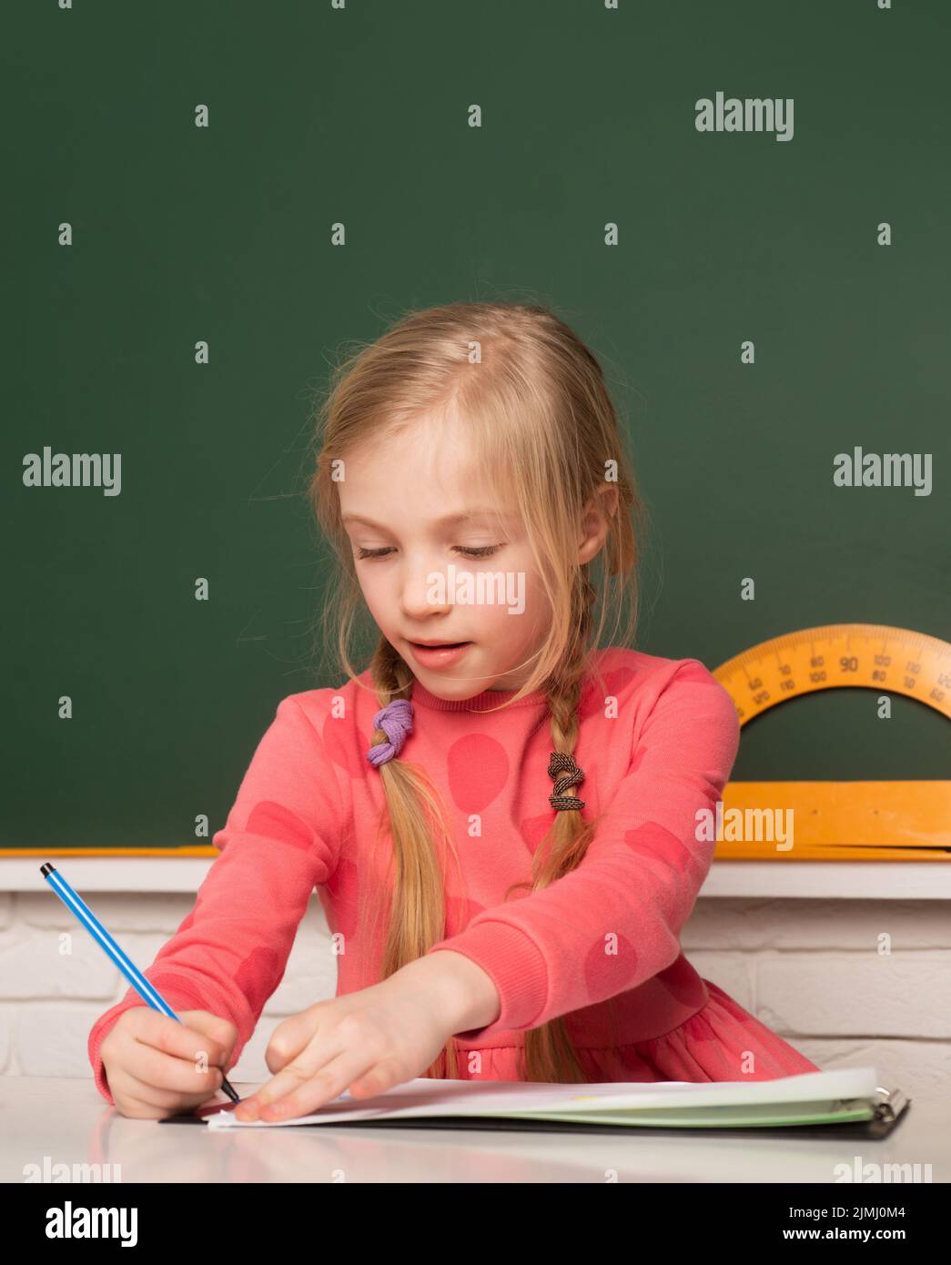 School concept. Kids drawing in notepad. Little girl pupil study in ...