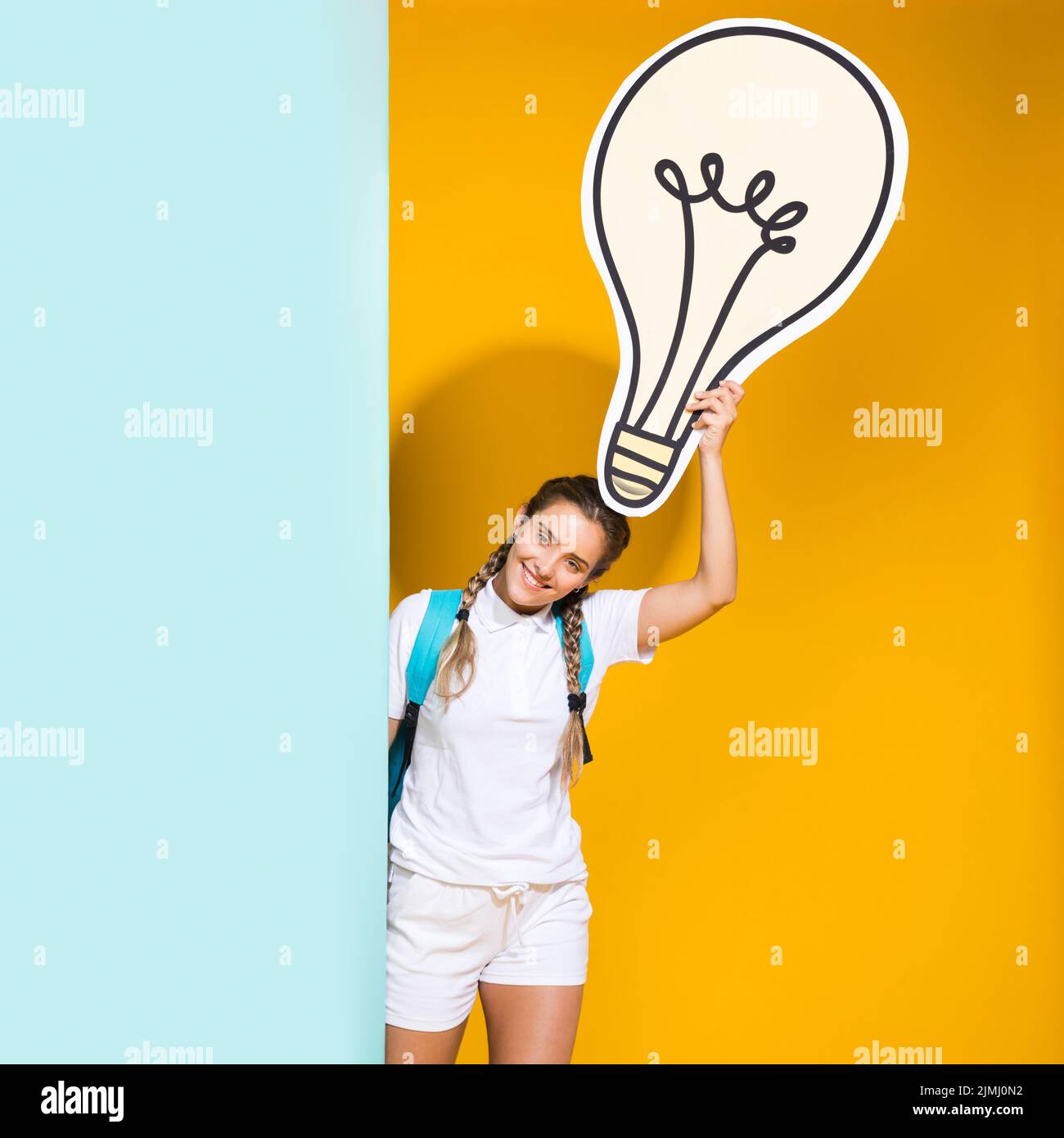 Portrait schoolgirl with big light bulb Stock Photo - Alamy