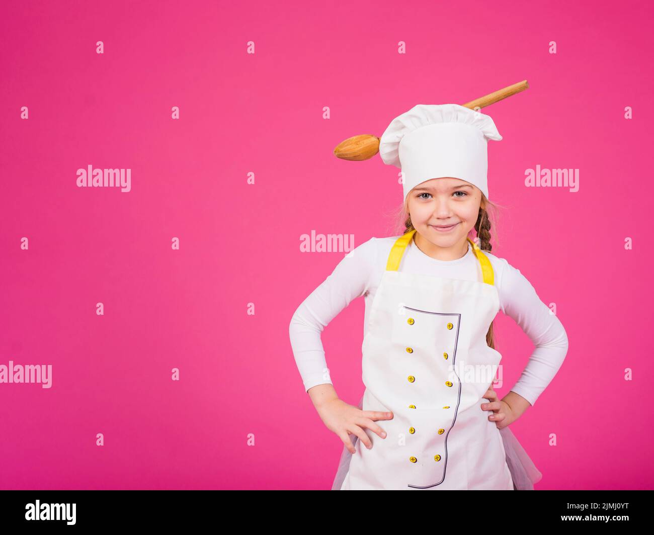 Cute girl cook standing with ladle chefs hat Stock Photo - Alamy