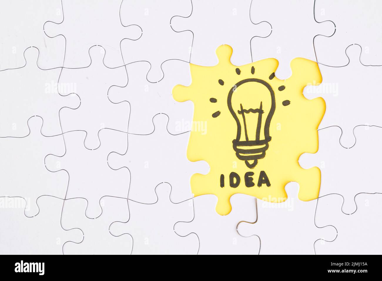 Yellow idea jigsaw puzzle stand out from white pieces Stock Photo - Alamy