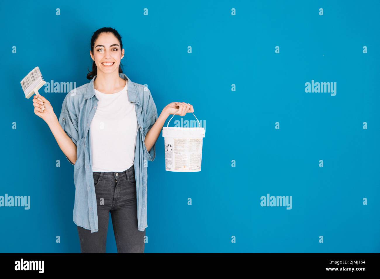 Woman holding brush bucket Stock Photo - Alamy