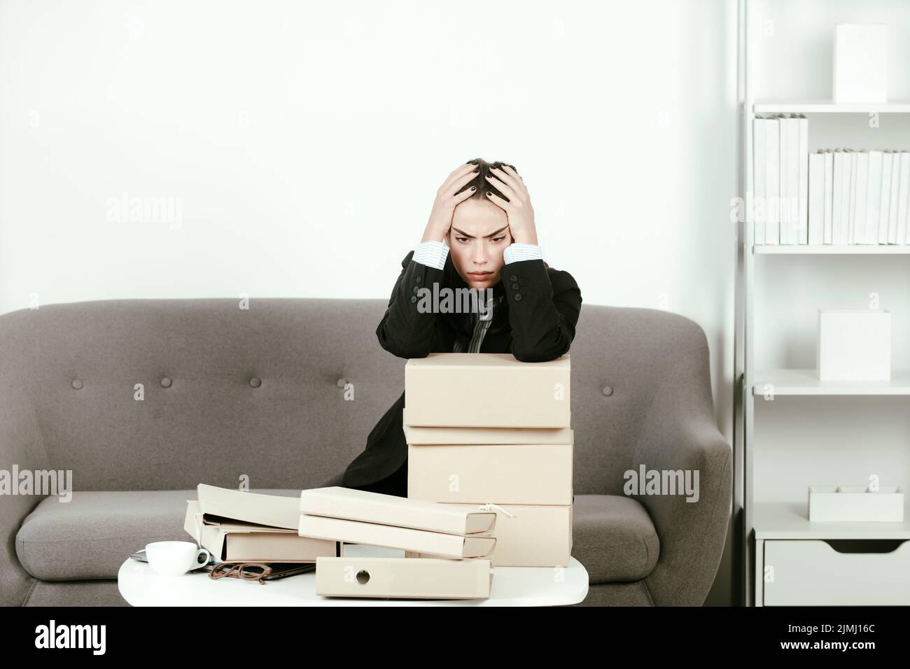 Sad secretary girl with folders with the documents , stressed ...