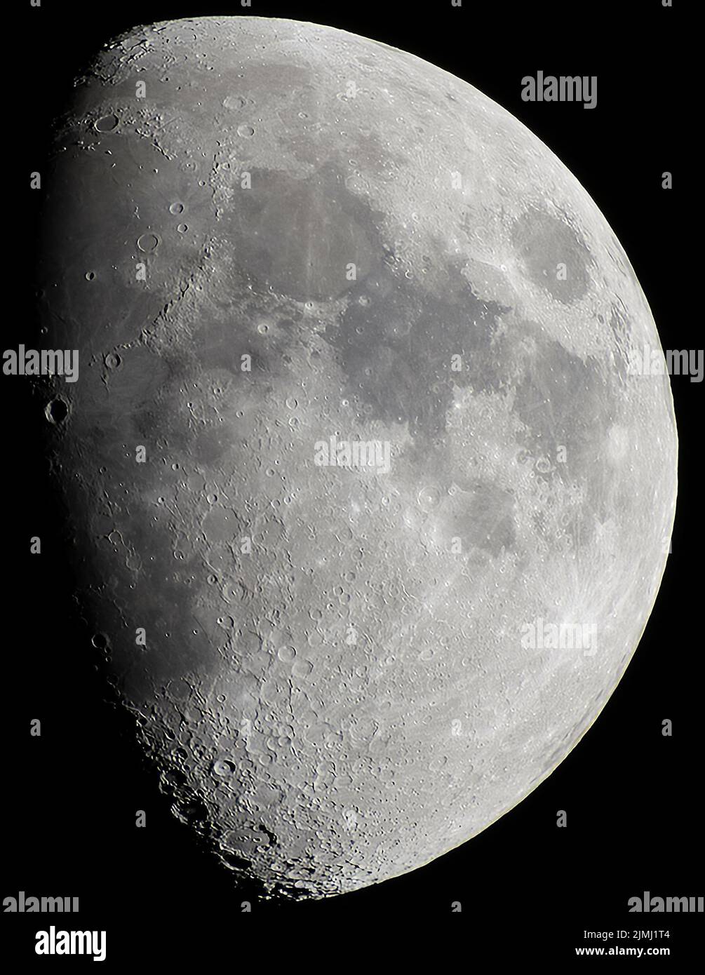 A vertical shot of details on a gray moon surface Stock Photo - Alamy