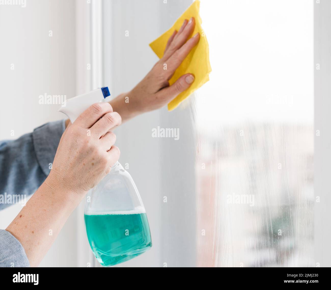 Side view woman washing window Stock Photo - Alamy