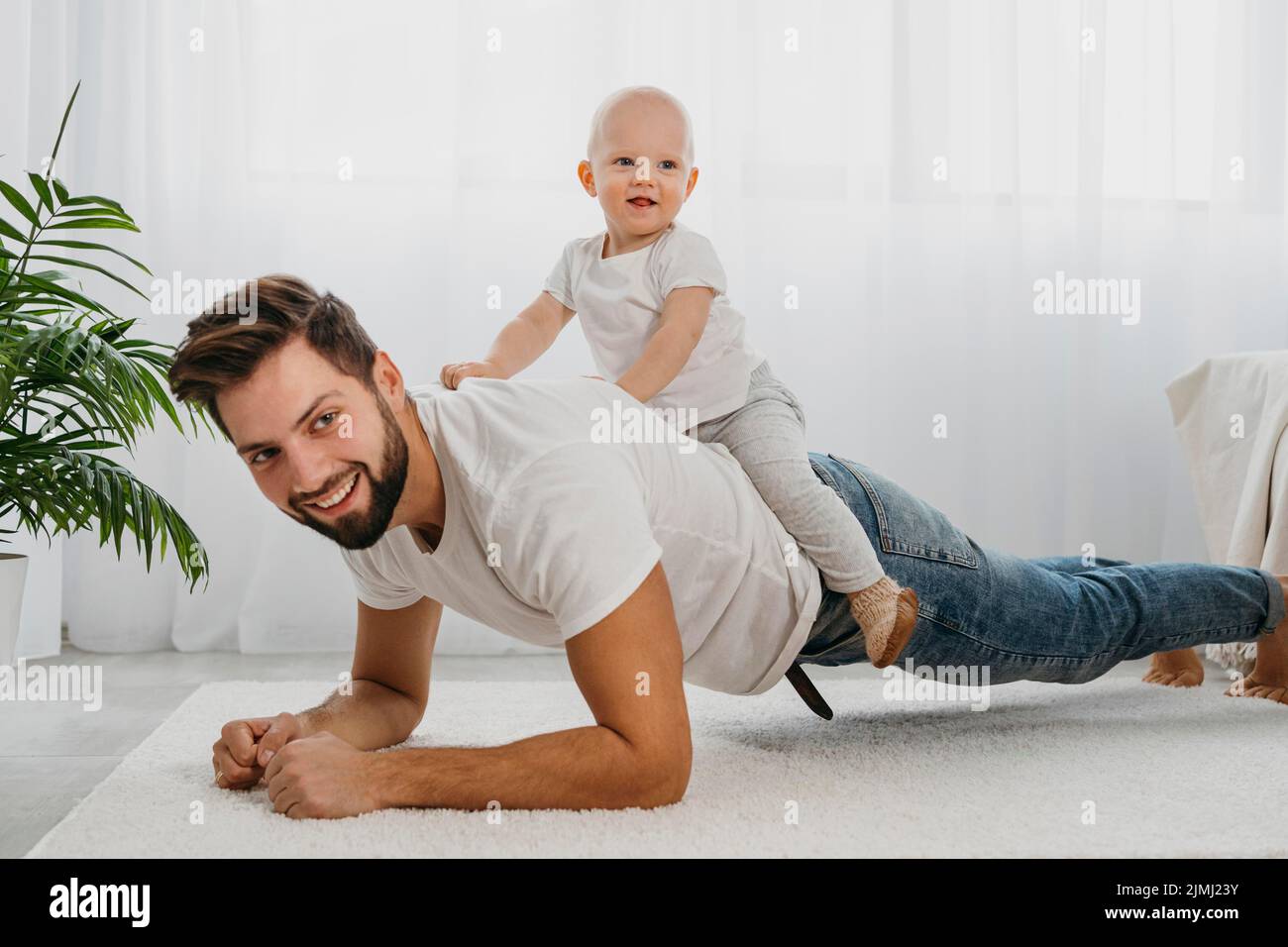 Happy father baby playing together home Stock Photo - Alamy
