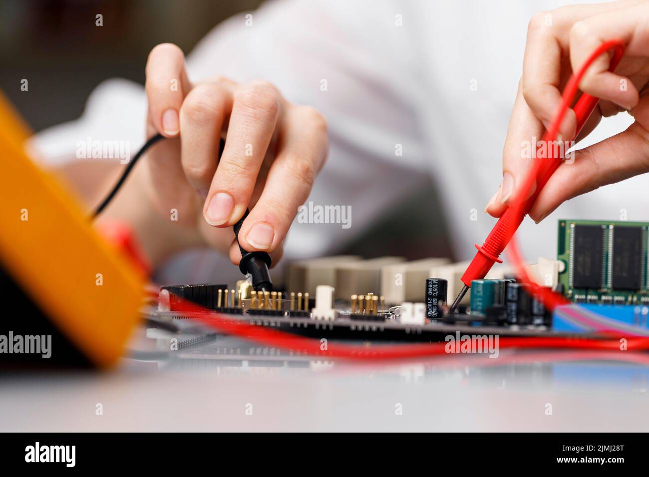 Front view female technician with computer motherboard Stock Photo - Alamy