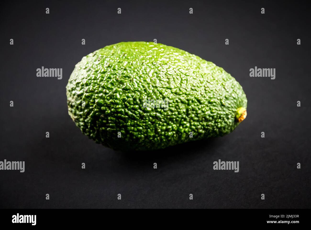 Avocado isolated on a black background Stock Photo - Alamy