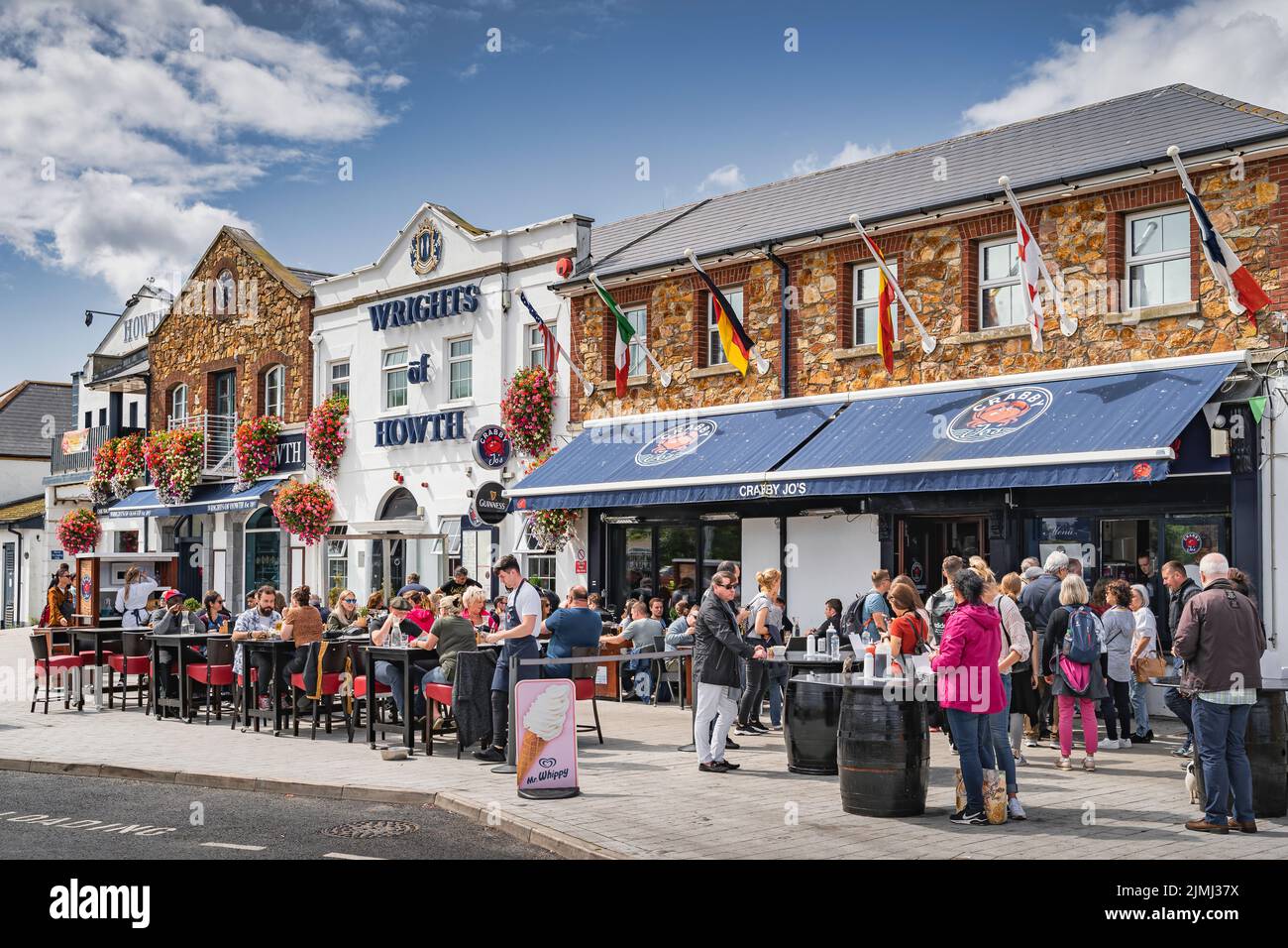 People enjoying nice weather in Dublin Howth and dining outdoors ...