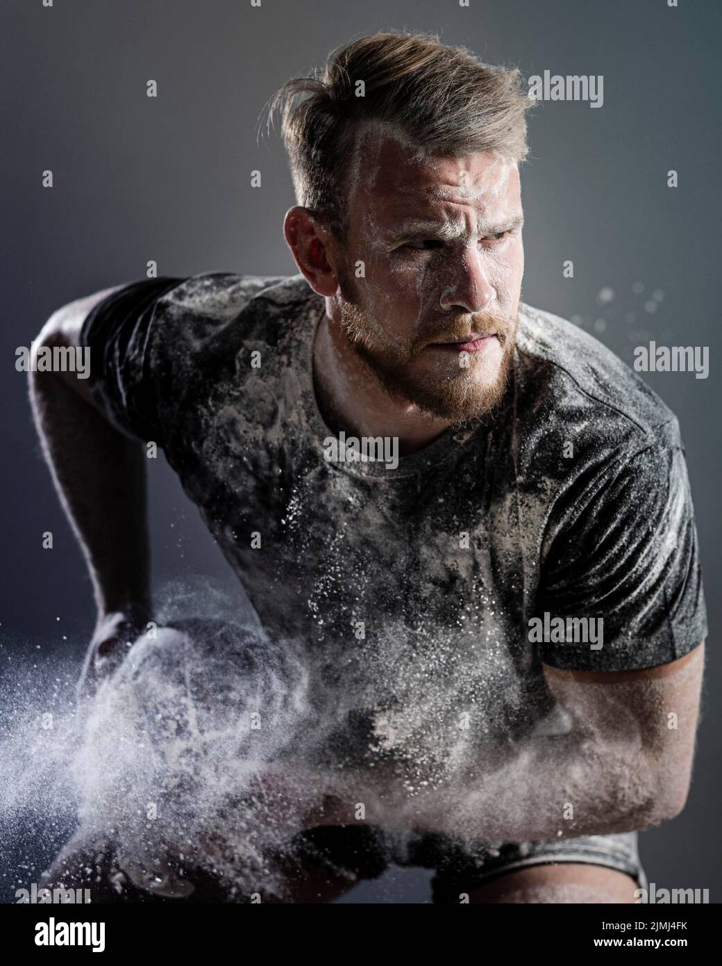Front view athletic male rugby player holding ball with dust Stock ...