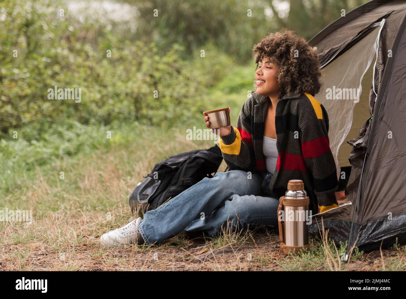 Side view woman enjoying view while camping outdoors Stock Photo - Alamy