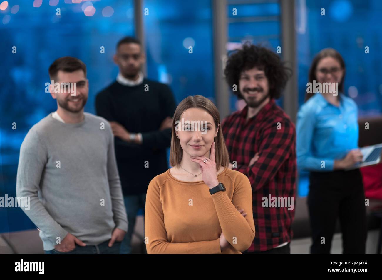 Portrait of successful creative business team looking at camera and ...